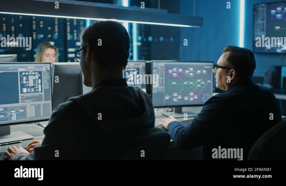 Team of IT Programers Working on Desktop Computers in Data Center ...