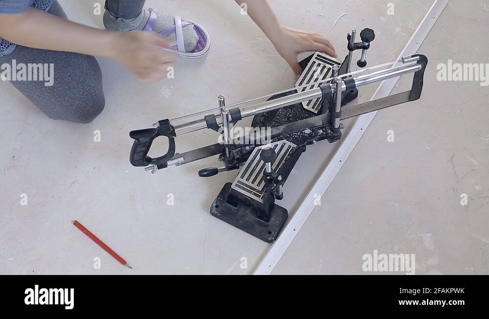 sawing with a hacksaw skirting Board for ceiling Stock Video Footage ...