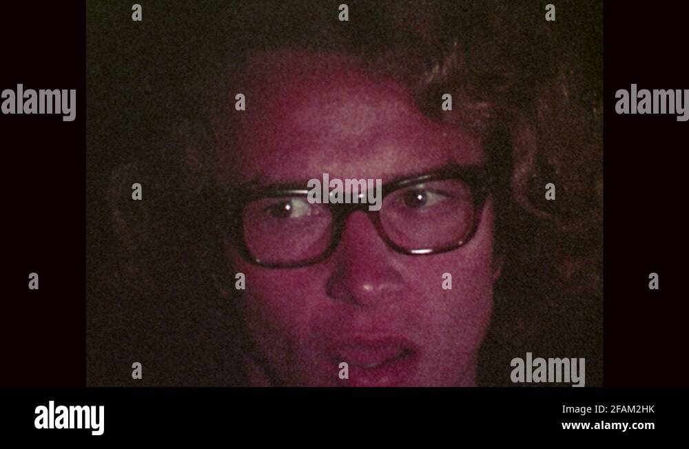 1970s: UNITED STATES: close up of man's face. Man moves eyes from side ...