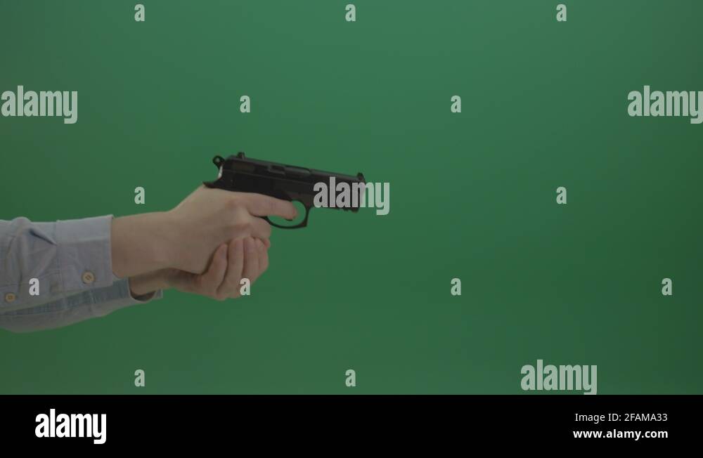 Man shooting from gun pistol isolated on green screen background Stock ...