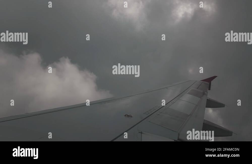 Severe turbulence when flying through thunderstorm clouds. The wing is ...