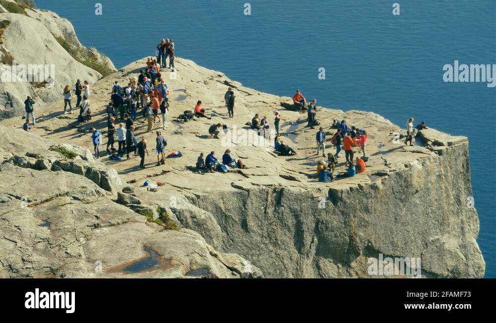 Crowded rock cliff edge mountain camp of Preikestolen Pulpit Rock in ...