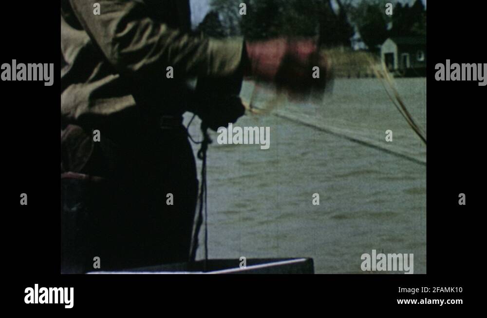 1950s: Men cast drift nets from small rowboat onto river Stock Video ...