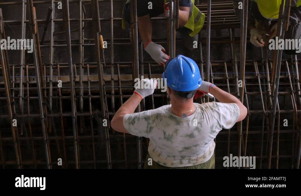 Construction workers install reinforcement Rebar on a industrial Stock ...
