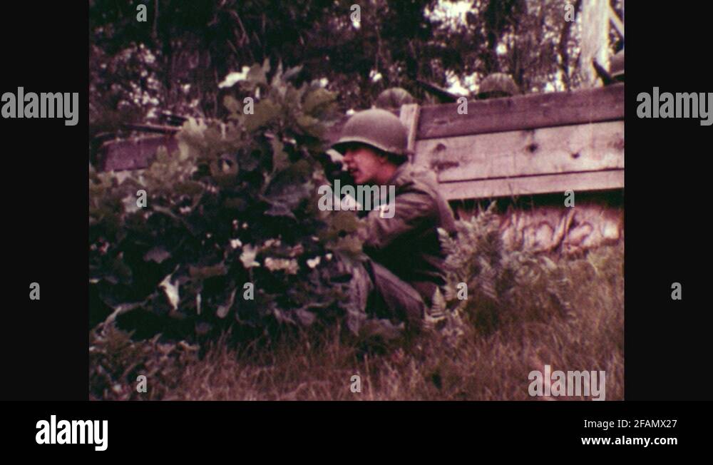 1970s: UNITED STATES: soldier with gun. Soldiers run from helicopter ...