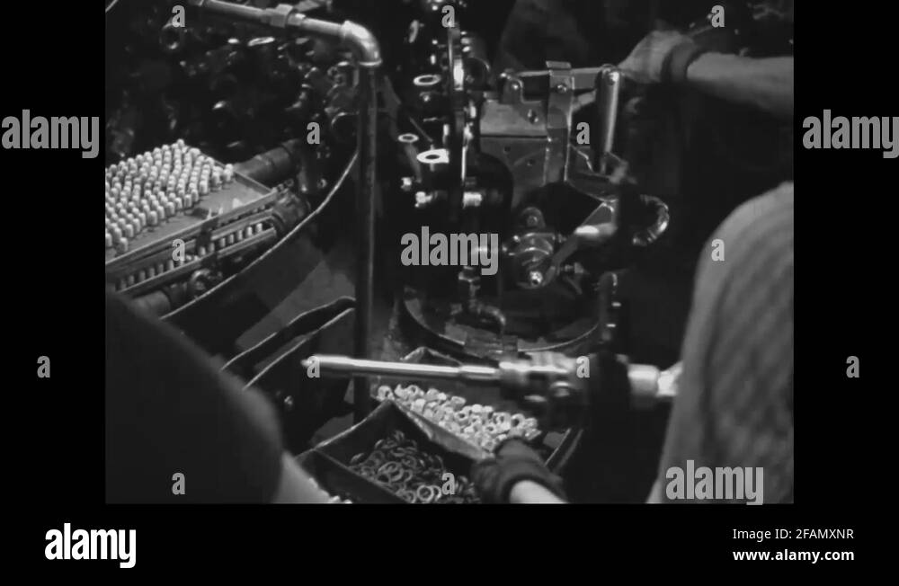 Workers fix screws of wheel hub on production line of automobile ...