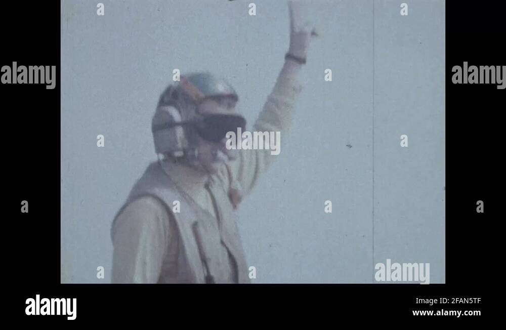 Aircraft marshaled direct aircraft on flight deck of aircraft carrier ...