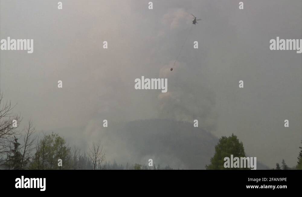 Bell 205A-1 helicopter dipping water during the West Fork Complex Fire ...