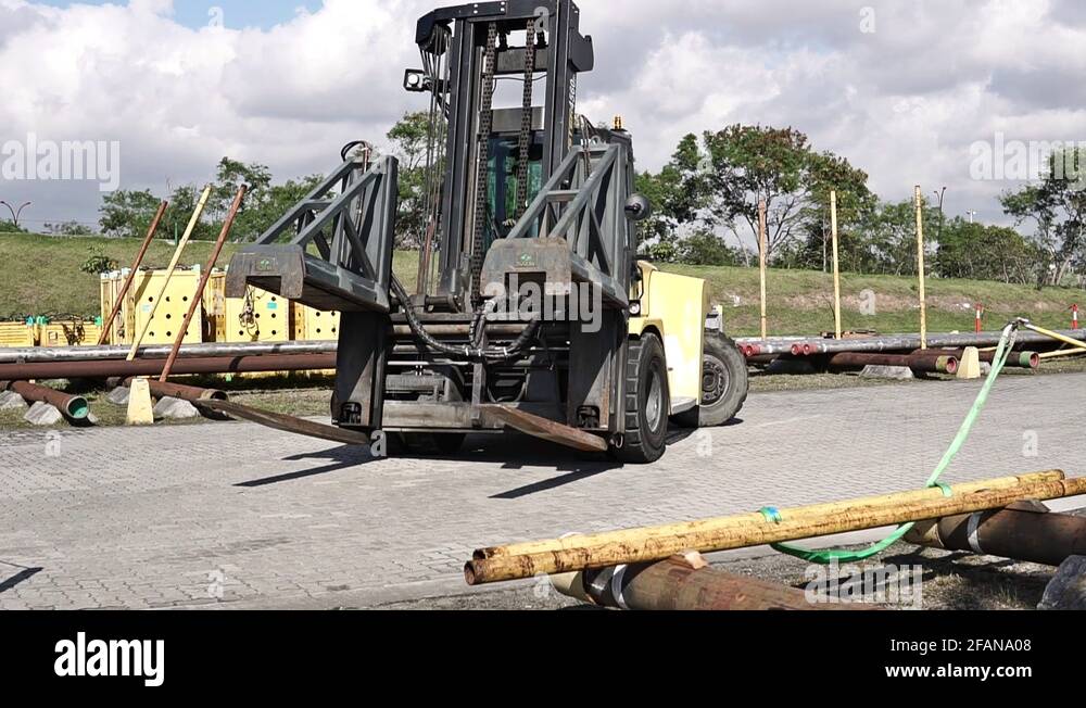 Forklift in operation, positioning to lift pipes Stock Video Footage ...