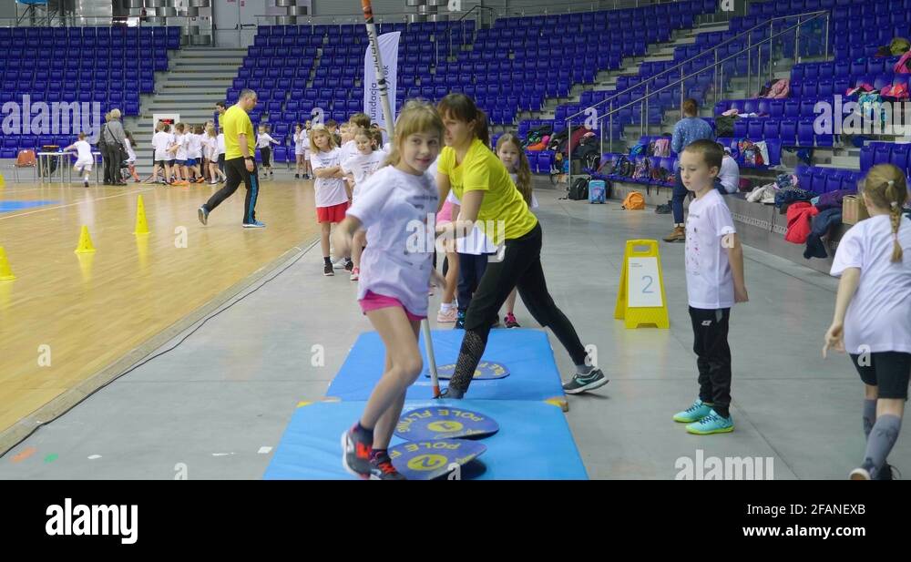 Kids lesson trainer helping kids pole vault indoors training to use the ...