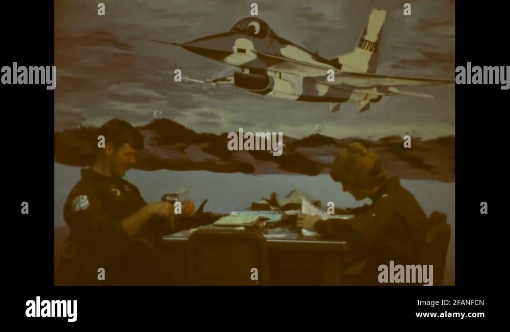 Trainee pilots at table and aircraft drawings on walls in a study hall ...