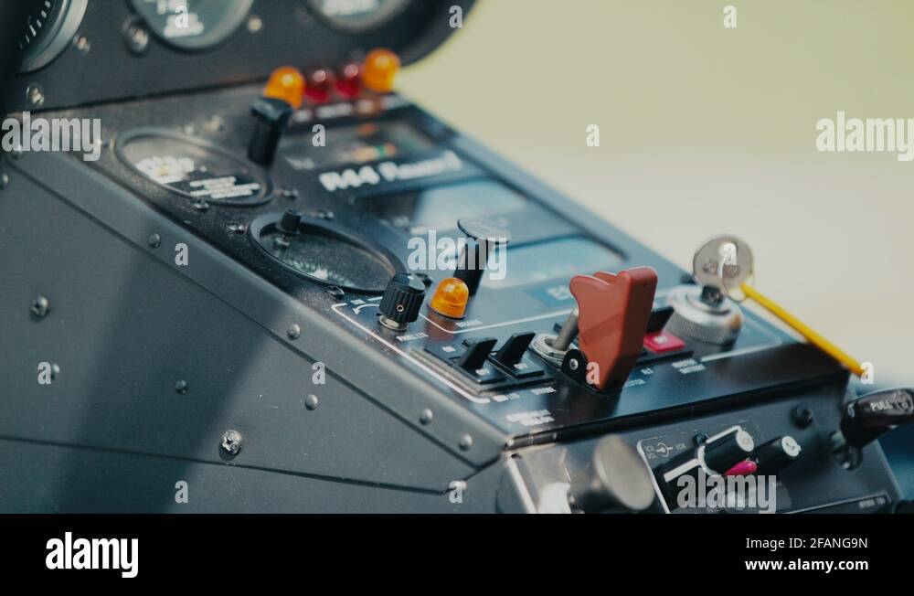 Slow pan of Robinson R44 instrument panel with pilot's hand starting ...