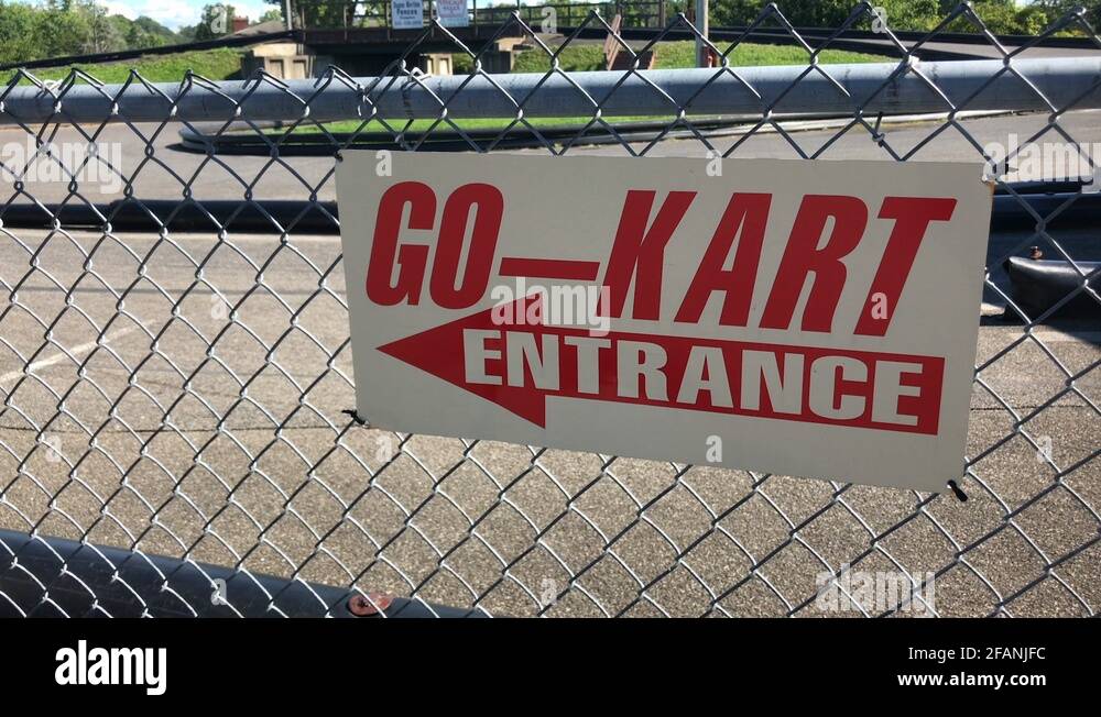 Go Kart sign with cars going by in background Stock Video Footage - Alamy