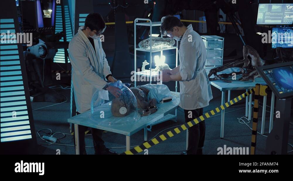 Alien connected to a respirator, lying on the operating table ...