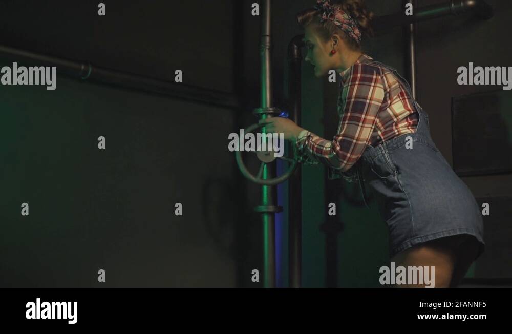 50s pin up woman with retro hairstyle is opening a valve and steam ...