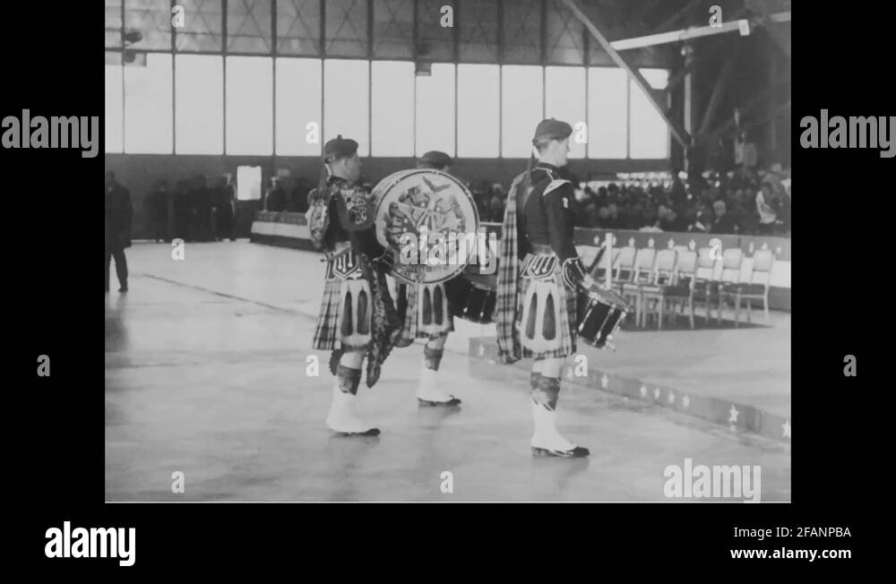 USAF Bagpipe Band perform in hangar and officers review from stand ...