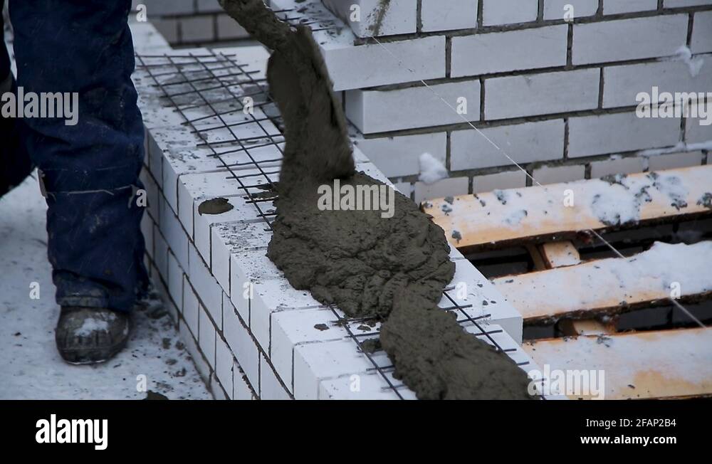Builder puts cement mortar with shovel and making brick masonry Stock ...