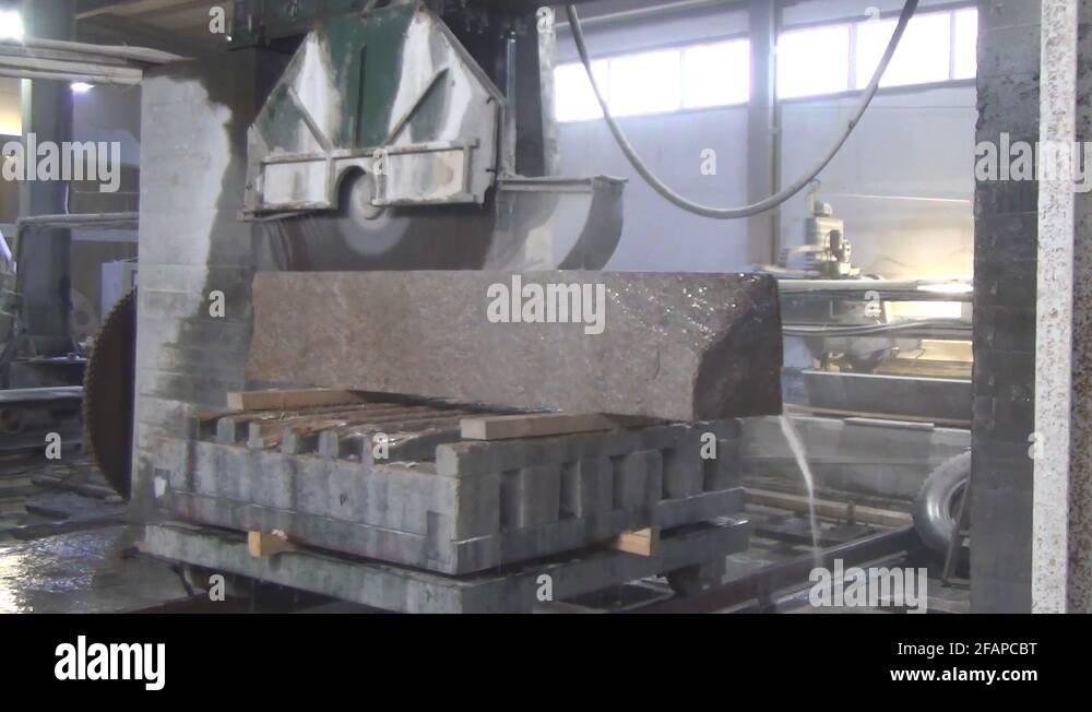 Granite processing in manufacturing. Cutting granite slab with a ...
