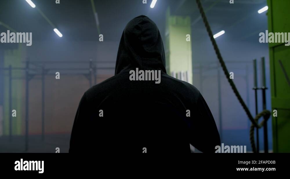 HANDHELD TRACKING African American male entering functional gym, taking ...