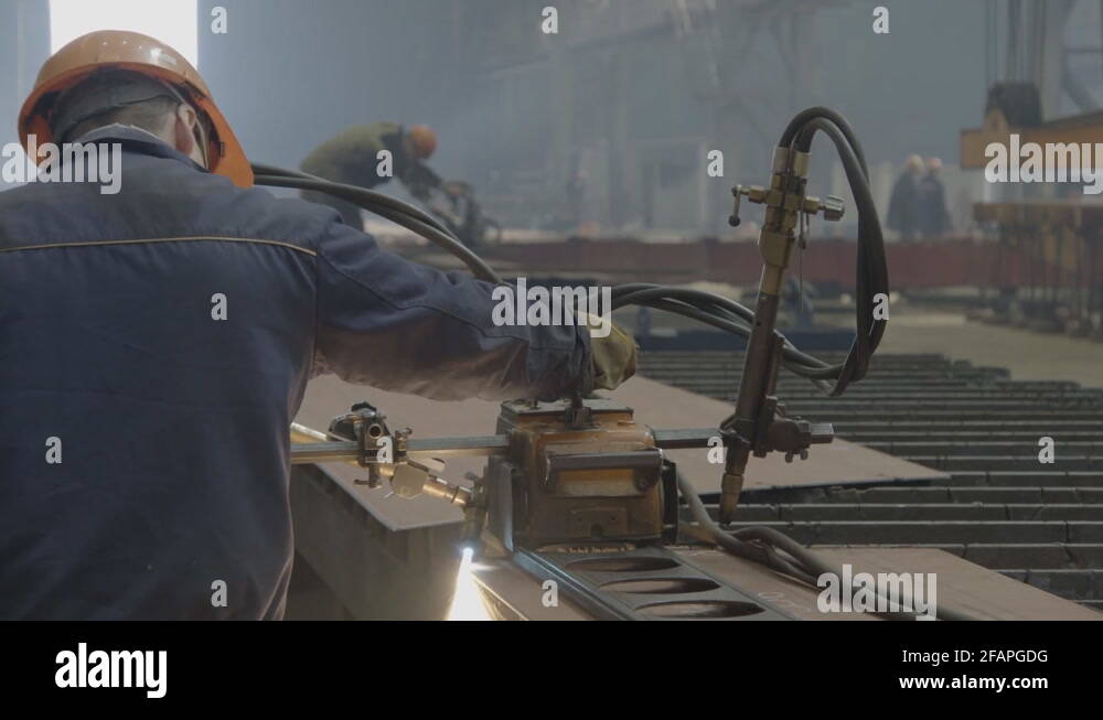 The worker welds the details with welding on the welding machine ...