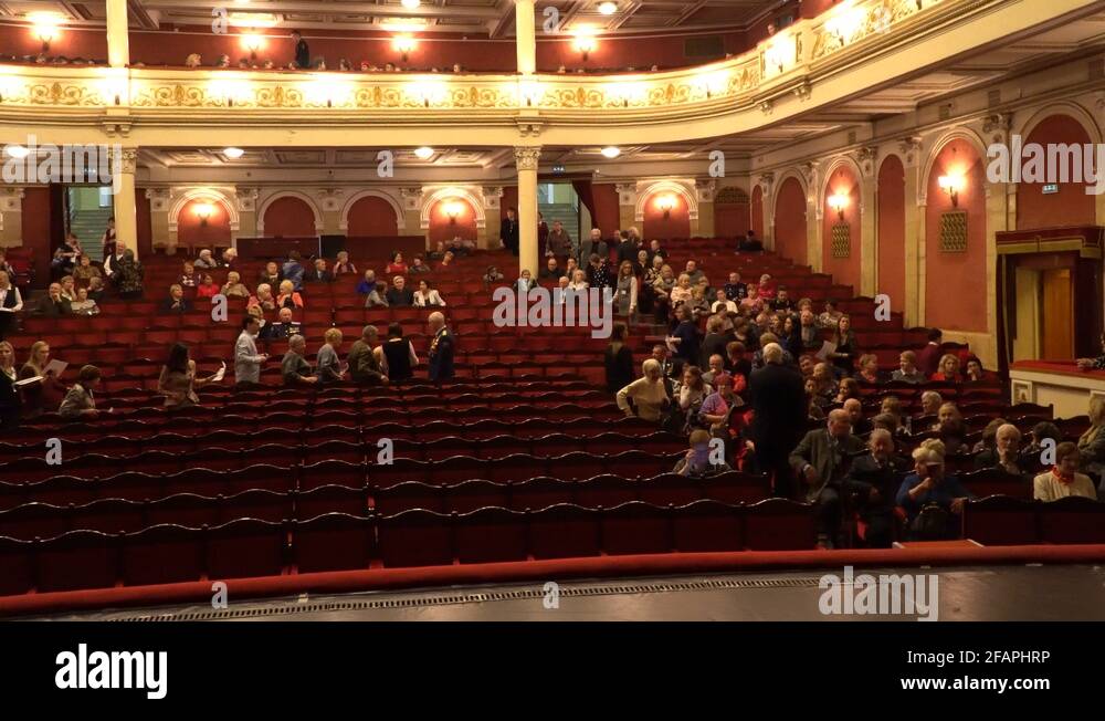 The auditorium of the famous opera house. People sit in their places ...