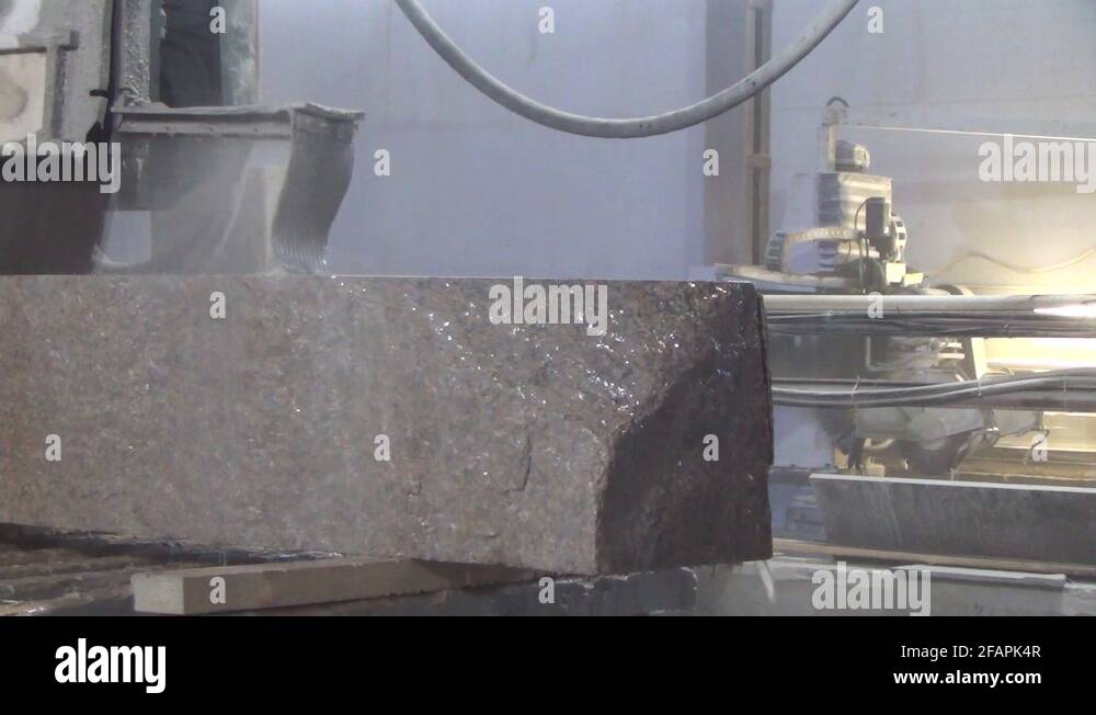 Granite processing in manufacturing. Cutting granite slab with a ...