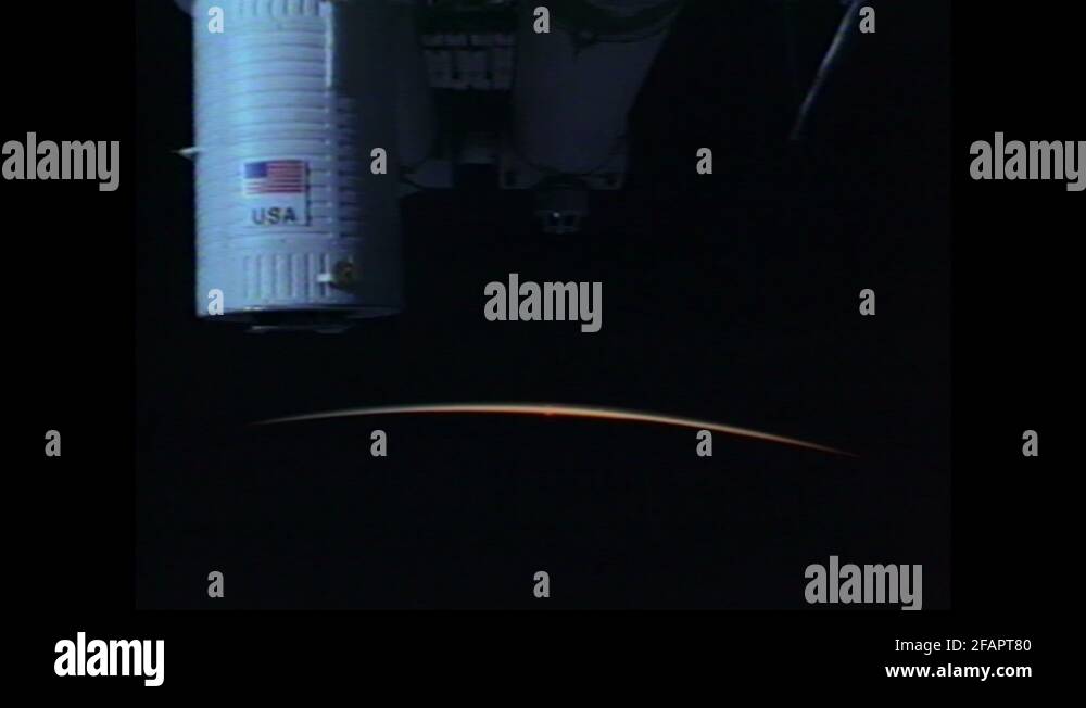 1990s: Space station orbits earth. Astronauts work on exterior of ...