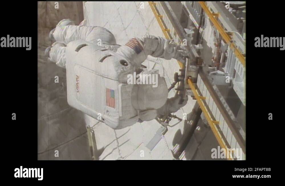 1990s: Astronaut working in bay of Space Shuttle in space. Astronaut ...