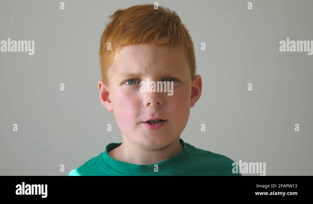 Amazed kid covers his mouth with hand and showing shock on his face ...