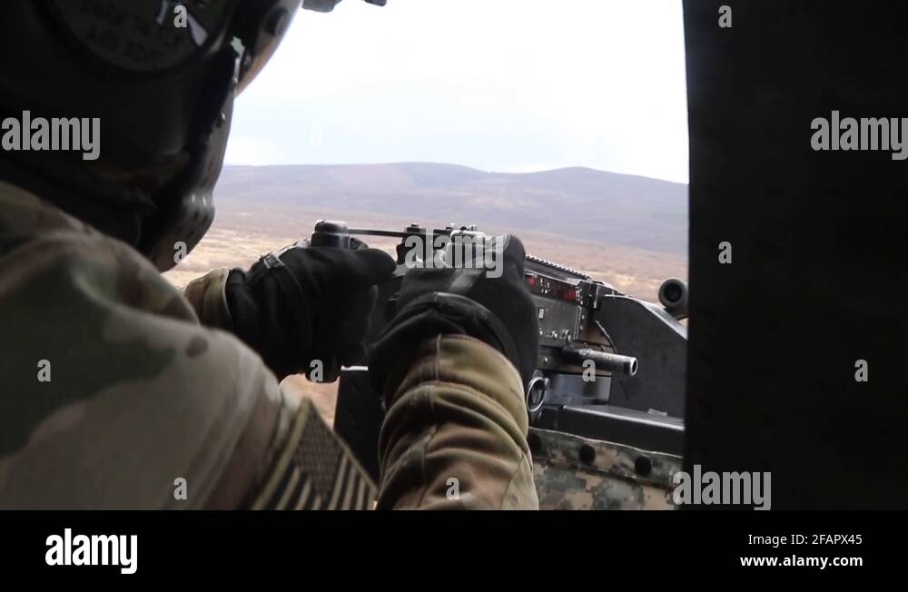 U.S. Army door gunner firing machine gun from helicopter Stock Video ...