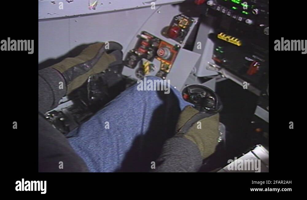 1990s: Hand moves joystick. Man operates flight simulator. Two men ...