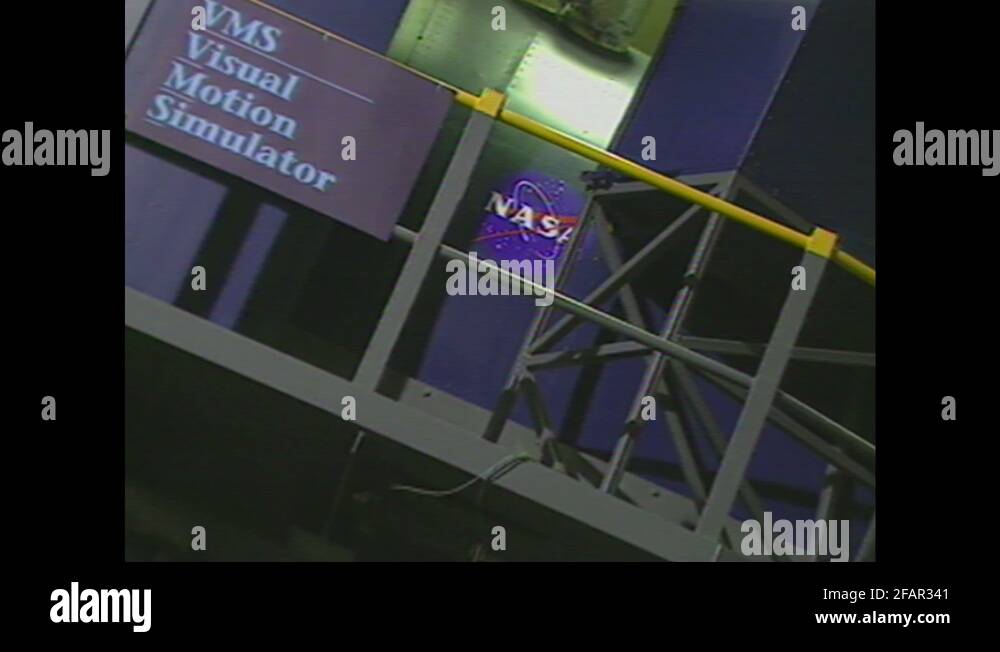 1990s: Zoom out on flight simulator. Man sitting in simulator Stock ...