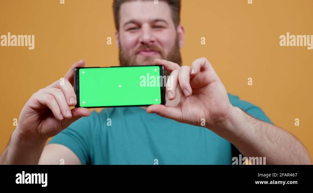 Man proudly shows his phone with green screen on Stock Video Footage ...