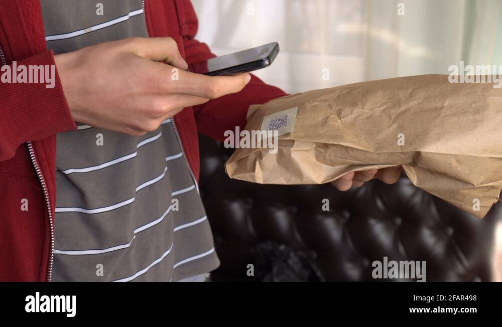 A man scanning a QR code on Product Packaging Stock Video Footage - Alamy