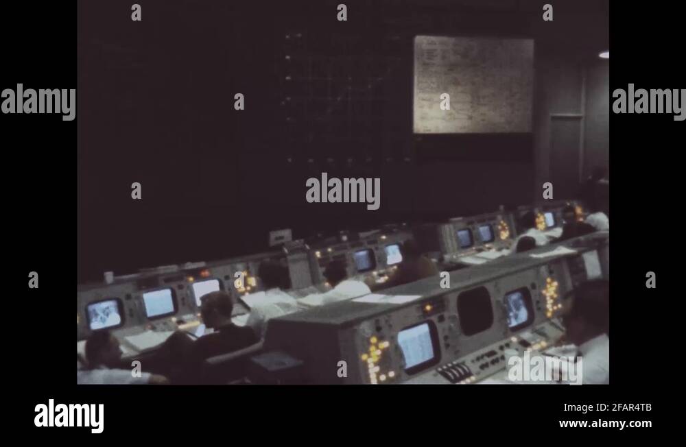 Technicians watch consoles and TV monitors at MOCR - 1966 Stock Video ...