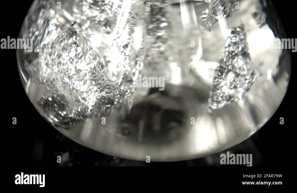 Seamlessly rotating silver in water in front of black background Stock ...