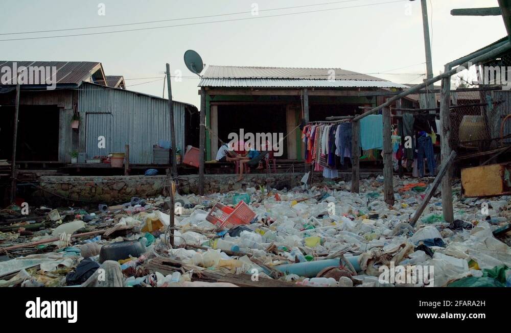 Plastic pollution in front of a house in a floating village in Cambodia ...