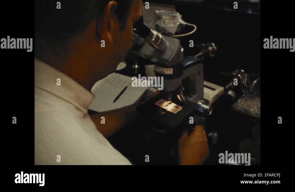 Doctors testing blood sample on microscope - 1969 Stock Video Footage ...