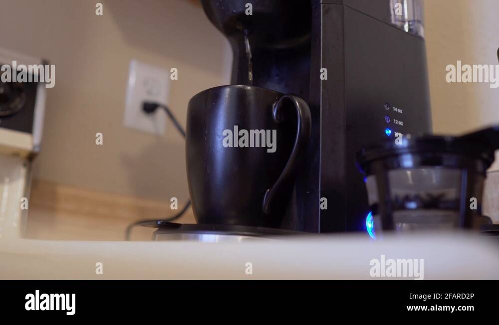 Coffee dripping into a coffee mug. Shallow depth of field. 24 fps ...