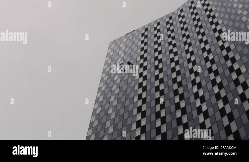 Two men cleaning windows on high rise tower Stock Video Footage - Alamy