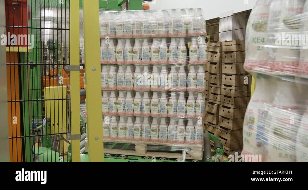 Dairy products, plastic milk bottles on pallets, packaging process of ...
