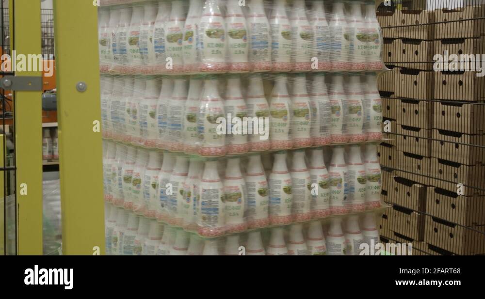 Dairy products, plastic milk bottles on pallets, packaging process of ...
