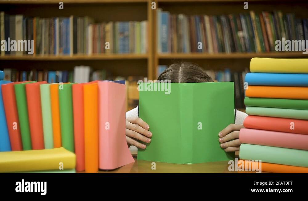 Girl hiding book Stock Videos & Footage - HD and 4K Video Clips - Alamy