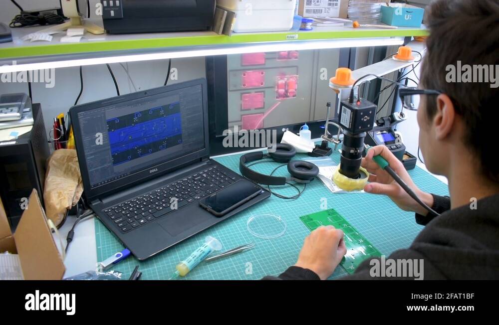A man micro soldering a PCB using an electronic magnifier Stock Video ...