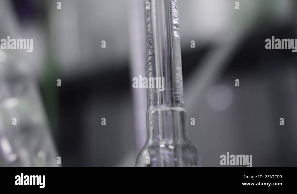 Chemical liquids in lab processes: mixing, reaction, solution in glass ...