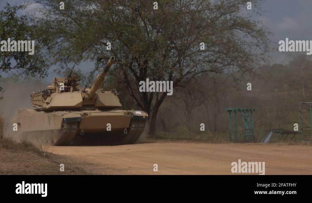 Abrams battle tank tracking at speed through Camp Ban Chan Krem ...