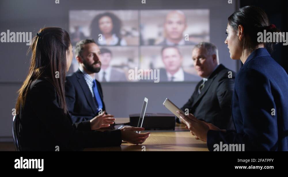 4K Business team connected to multiple colleagues on split screen video ...