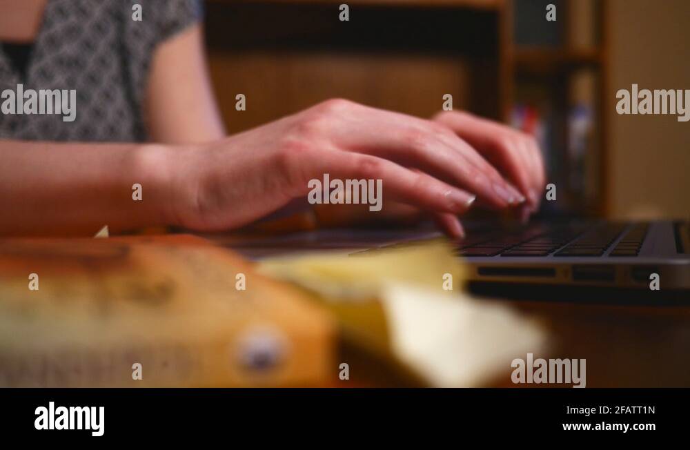 Woman Types on laptop computer slow motion shiny nails office setting ...