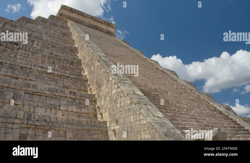 El Castillo pyramid at Chichen Itza with blue sky and clouds closer on ...
