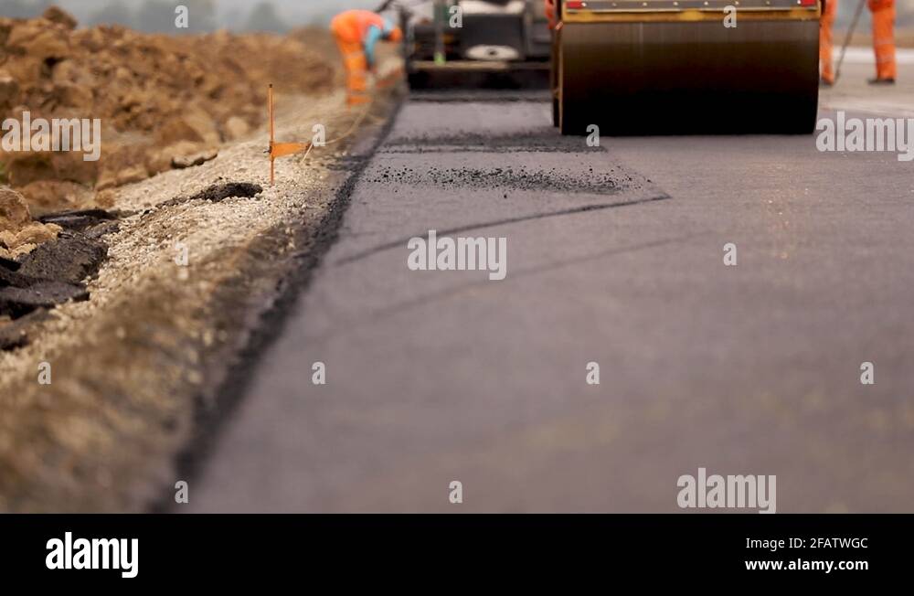 The paver mover on a flat newly made road, ramming and leveling ...